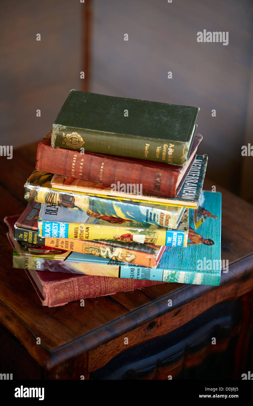 Pile of books sitting on a shelf Stock Photo - Alamy