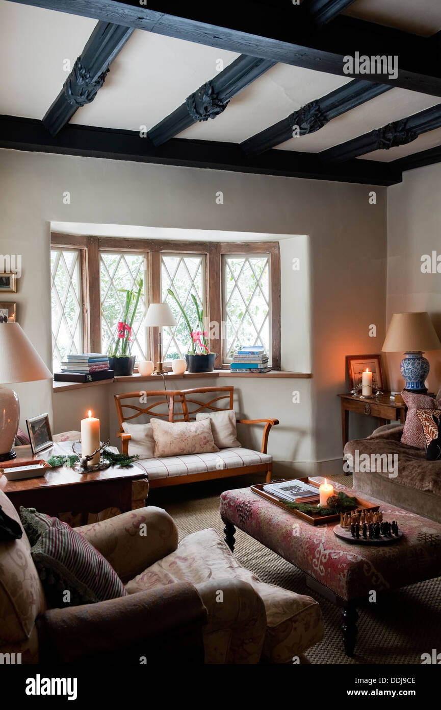 Kilim-covered ottoman in living room with ceiling beams and Howard ...