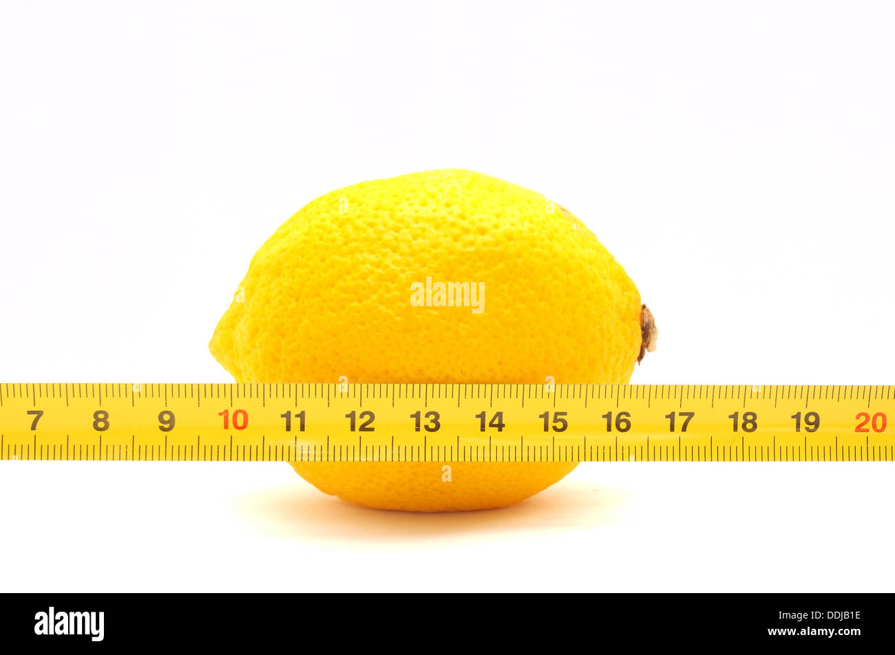 Lemon and ruler on a white background Stock Photo - Alamy