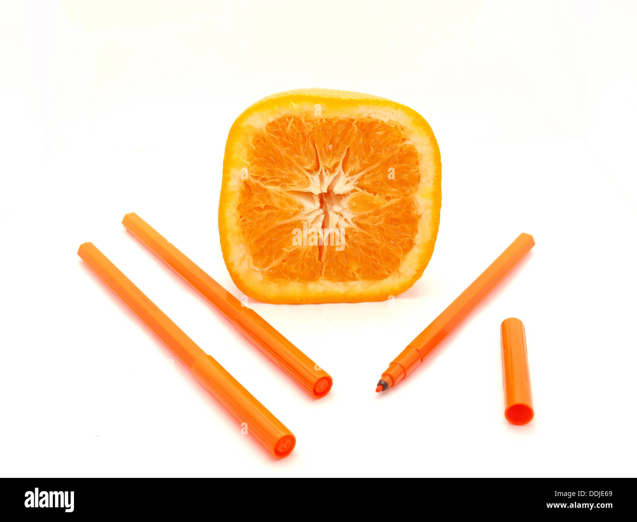 Square orange and felt-tip pens on a white background Stock Photo - Alamy