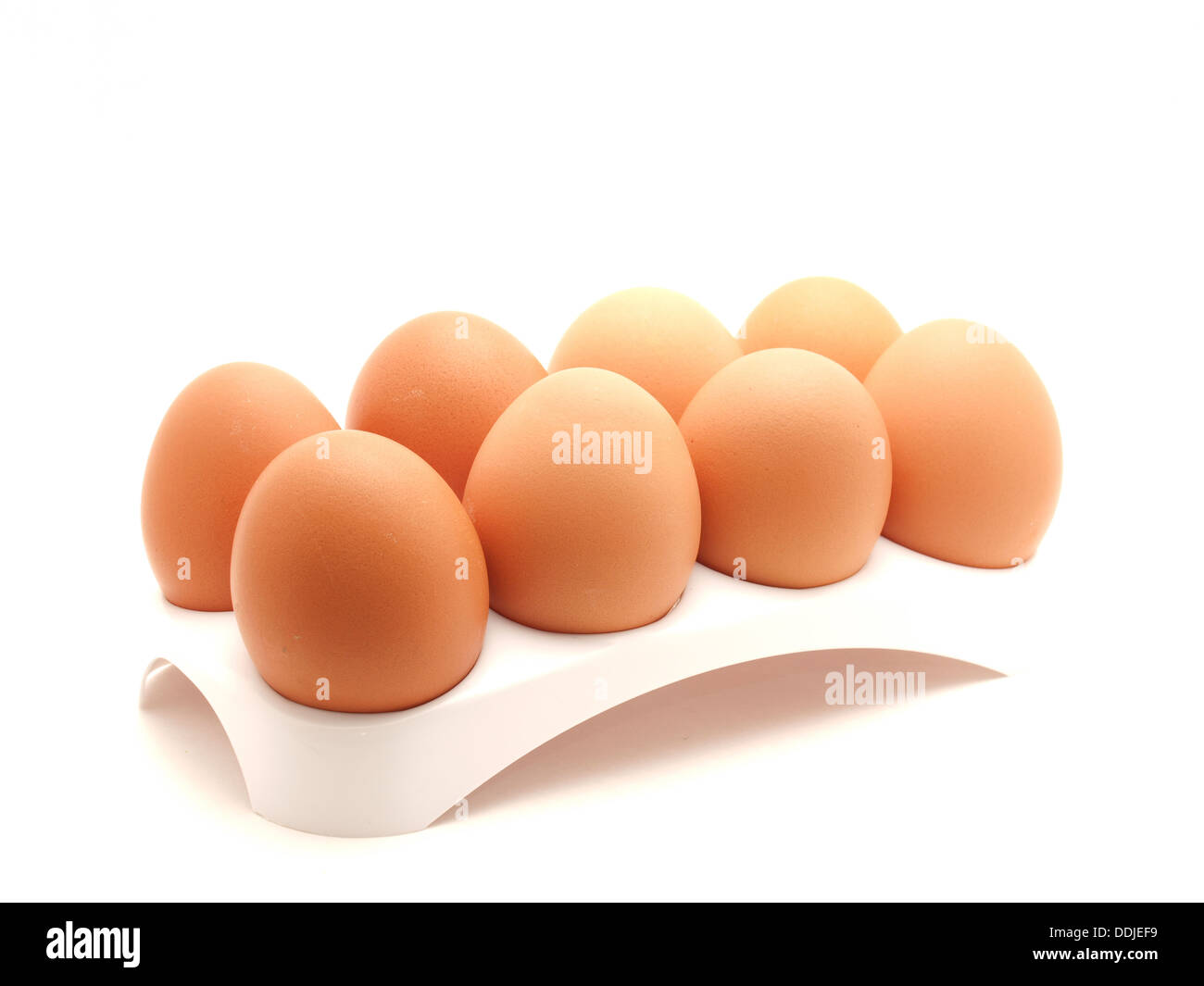 Eggs on a support on a white background Stock Photo - Alamy