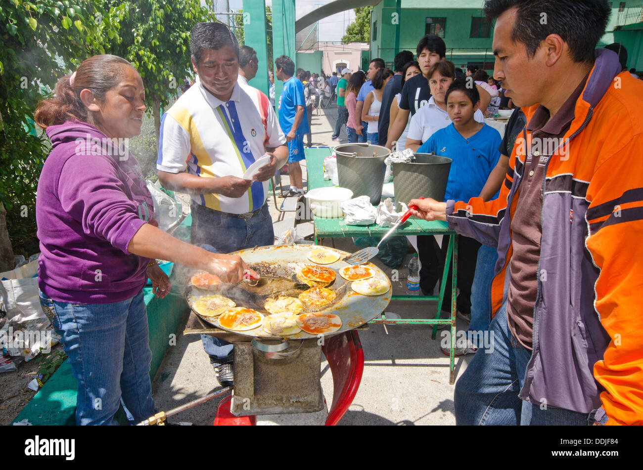 Food festival in Puebla city, Mexico. A woman prepares chalupas for ...