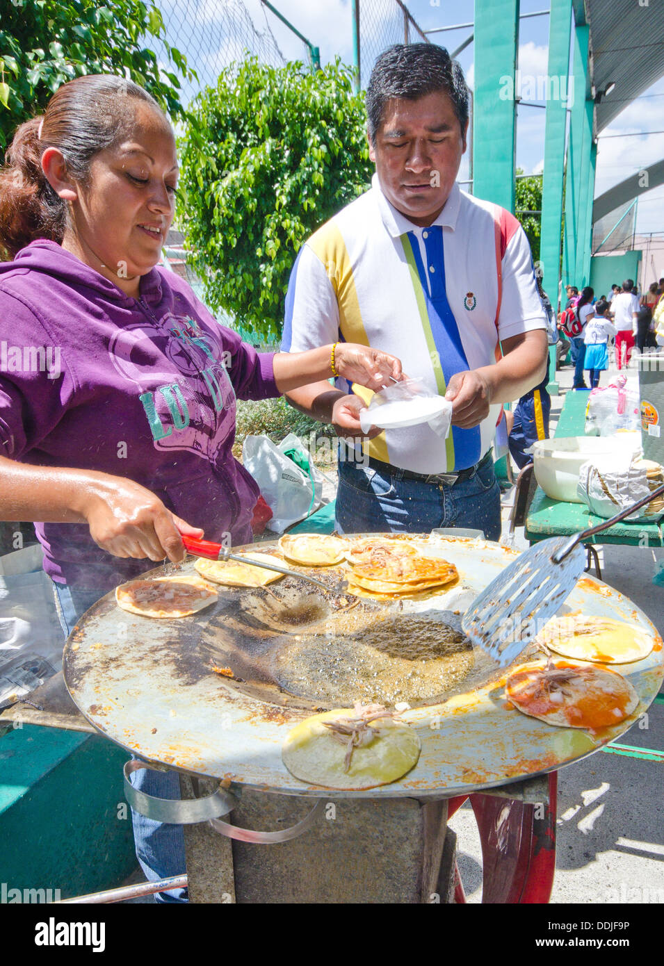 Food festival in Puebla city, Mexico. A woman prepares chalupas for ...