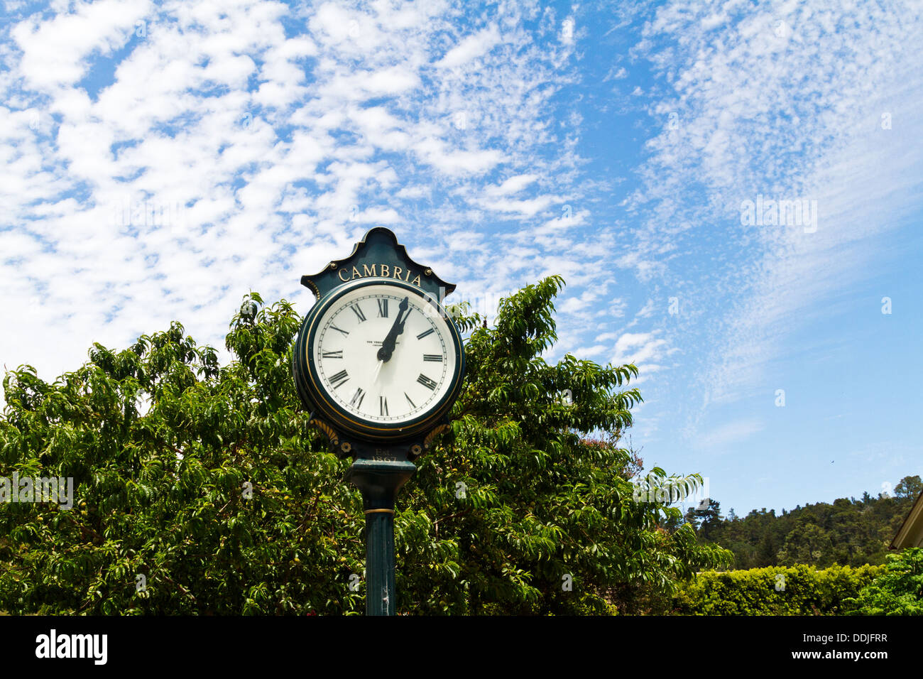 Clock in downtown Cambria, California shows the time against a backdrop ...