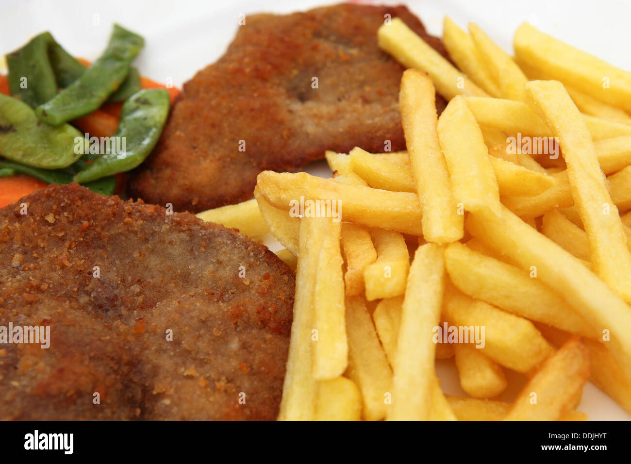 Vienna style Schnitzel is served with chips in Wiesbaden, Germany Stock ...