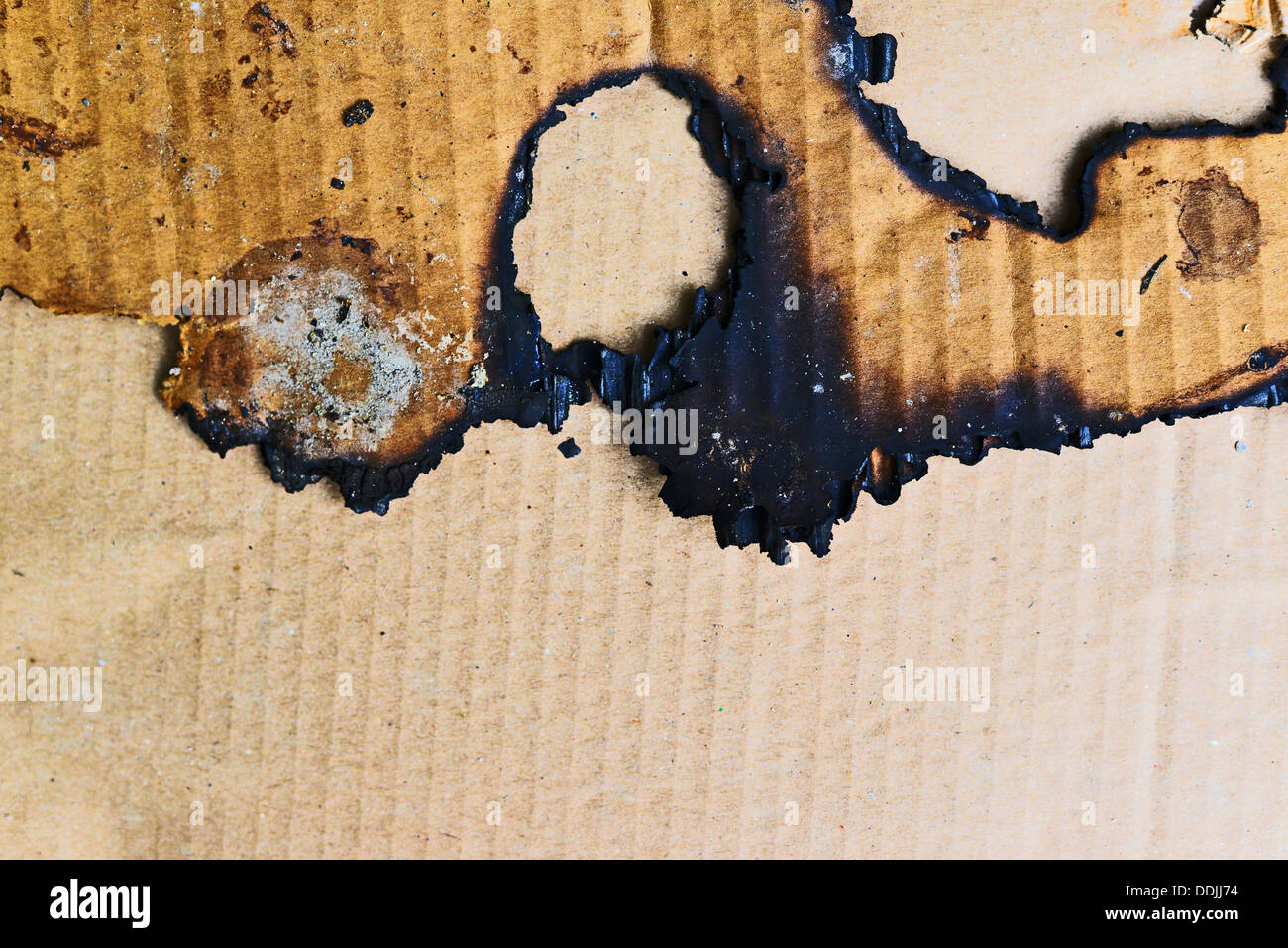 Burned cardboard texture with fire marks as background Stock Photo - Alamy