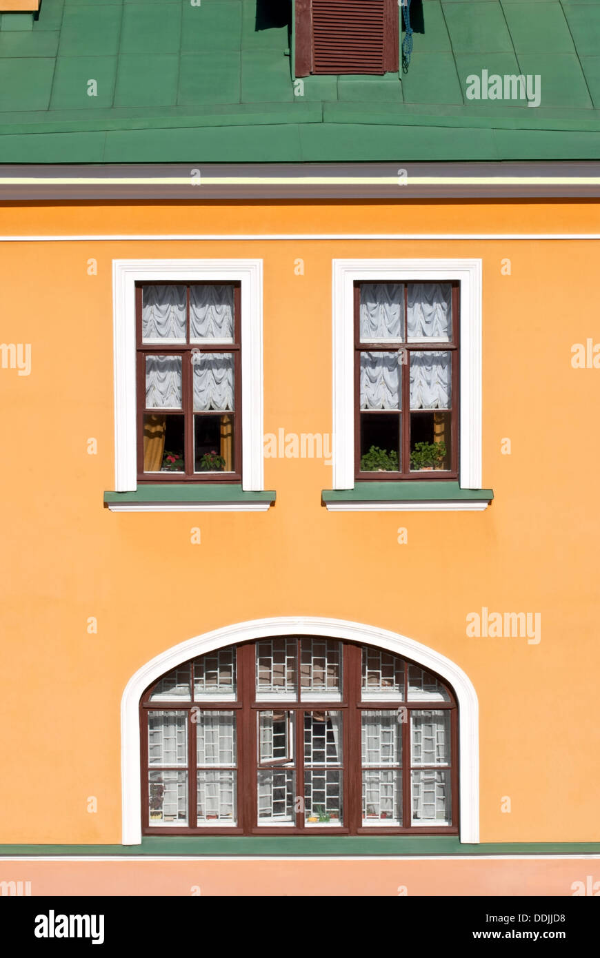 Window on the yellow facade of a residential building Stock Photo - Alamy