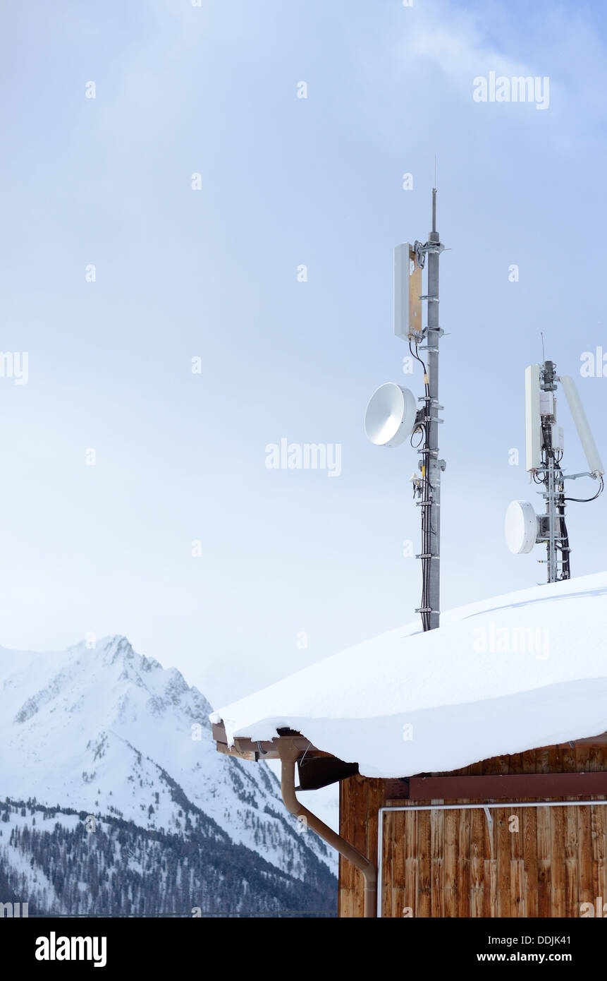 Snow mast aerial satellite dish on a wooden cabin, at Kappl Ski slope ...