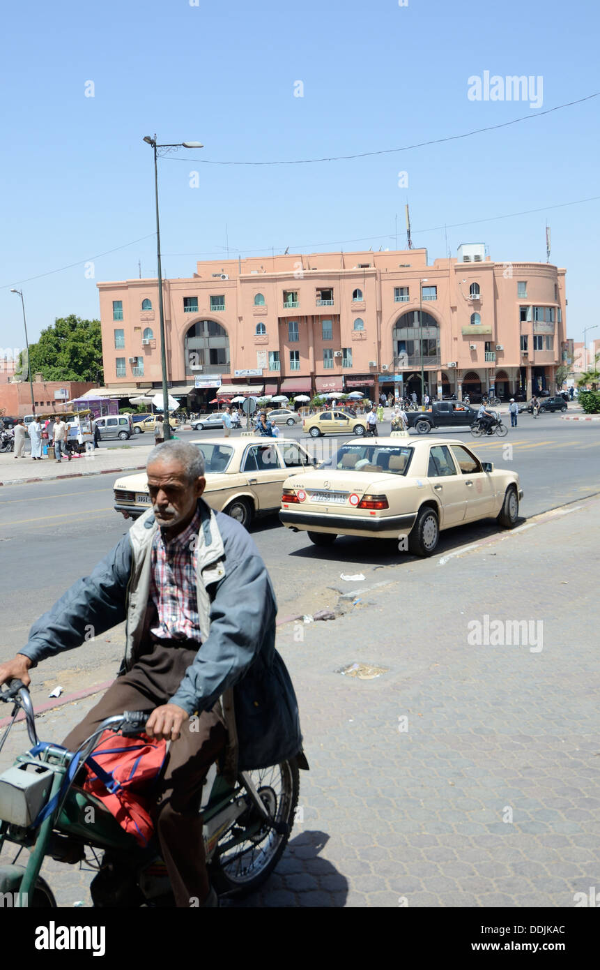 Marrakech Morocco with a busy street scene foreground with taxis ...