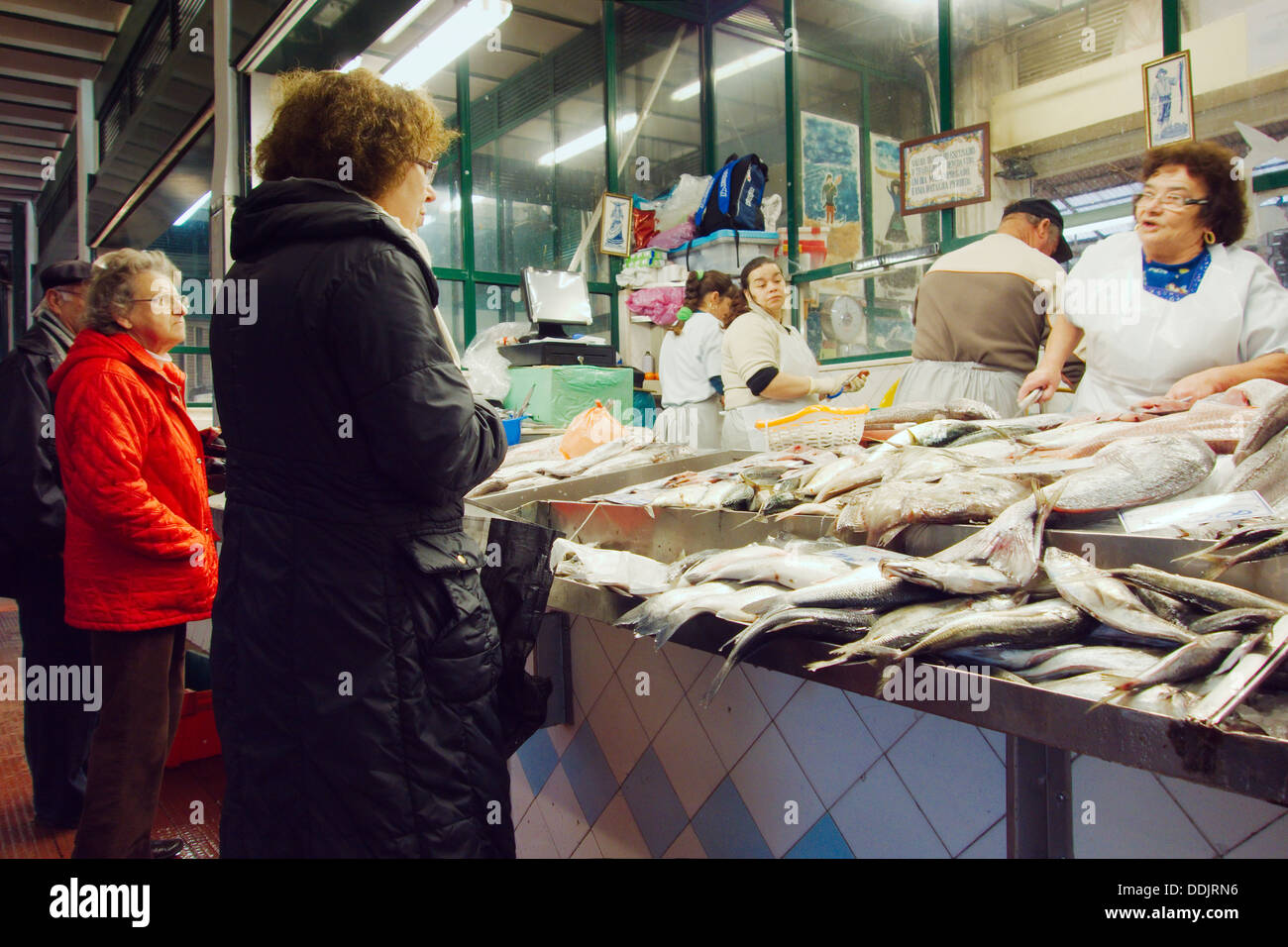 Fishmonger preparing the for a customer at Ribeira market Stock Photo ...