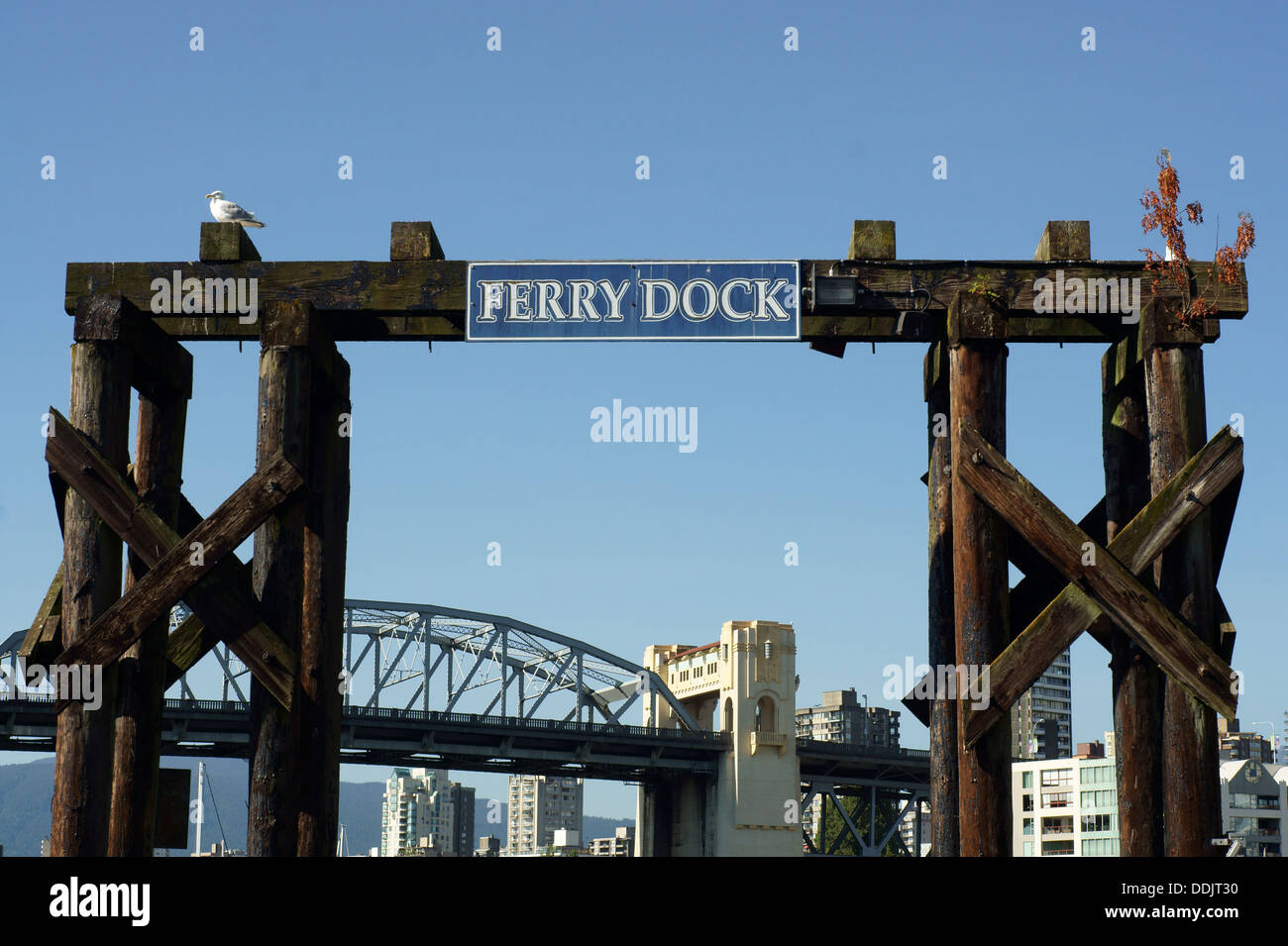 Wooden ferry dock sign with Burrard Bridge in background, Granville ...