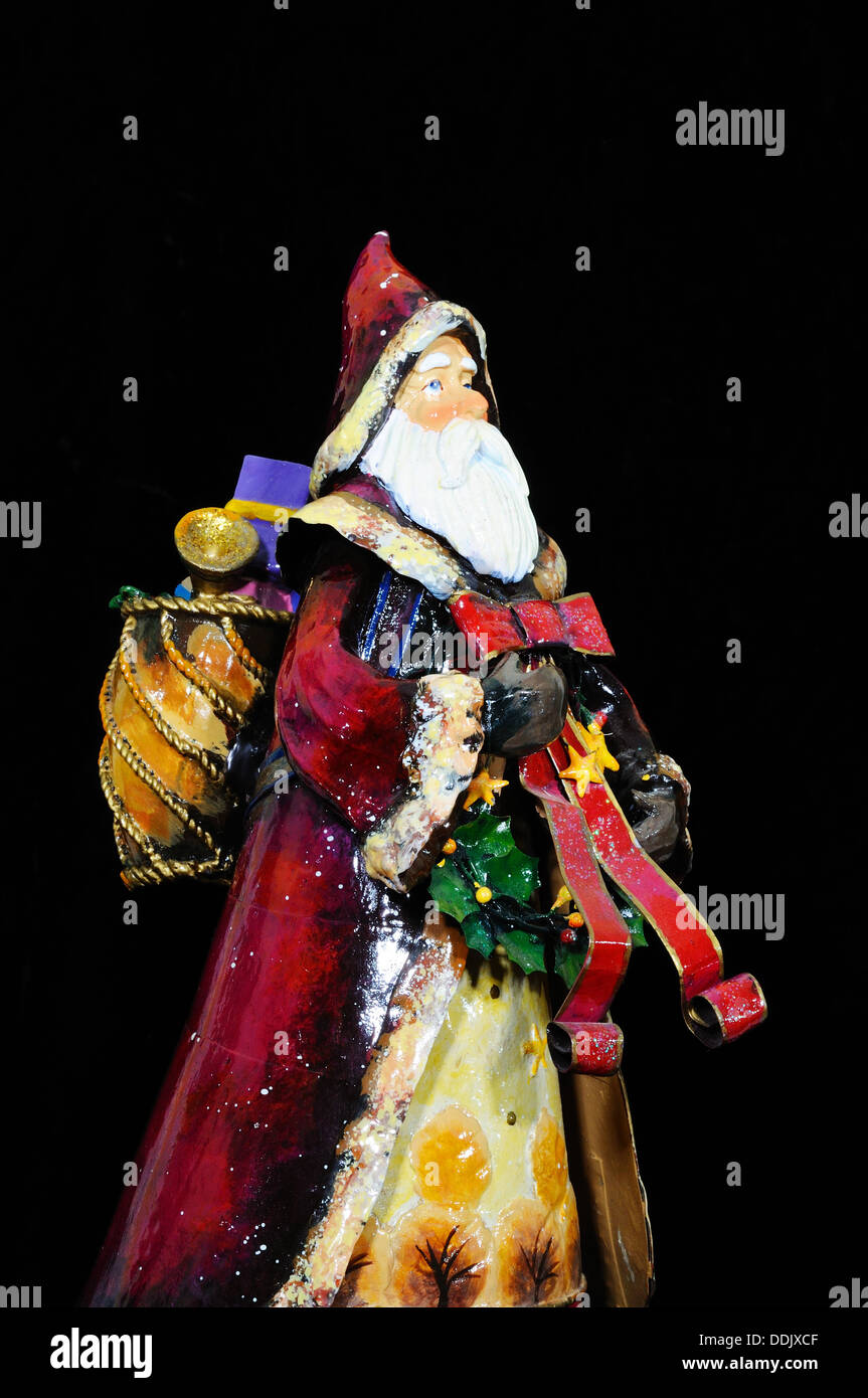 Tin Father Christmas on a black background Stock Photo - Alamy