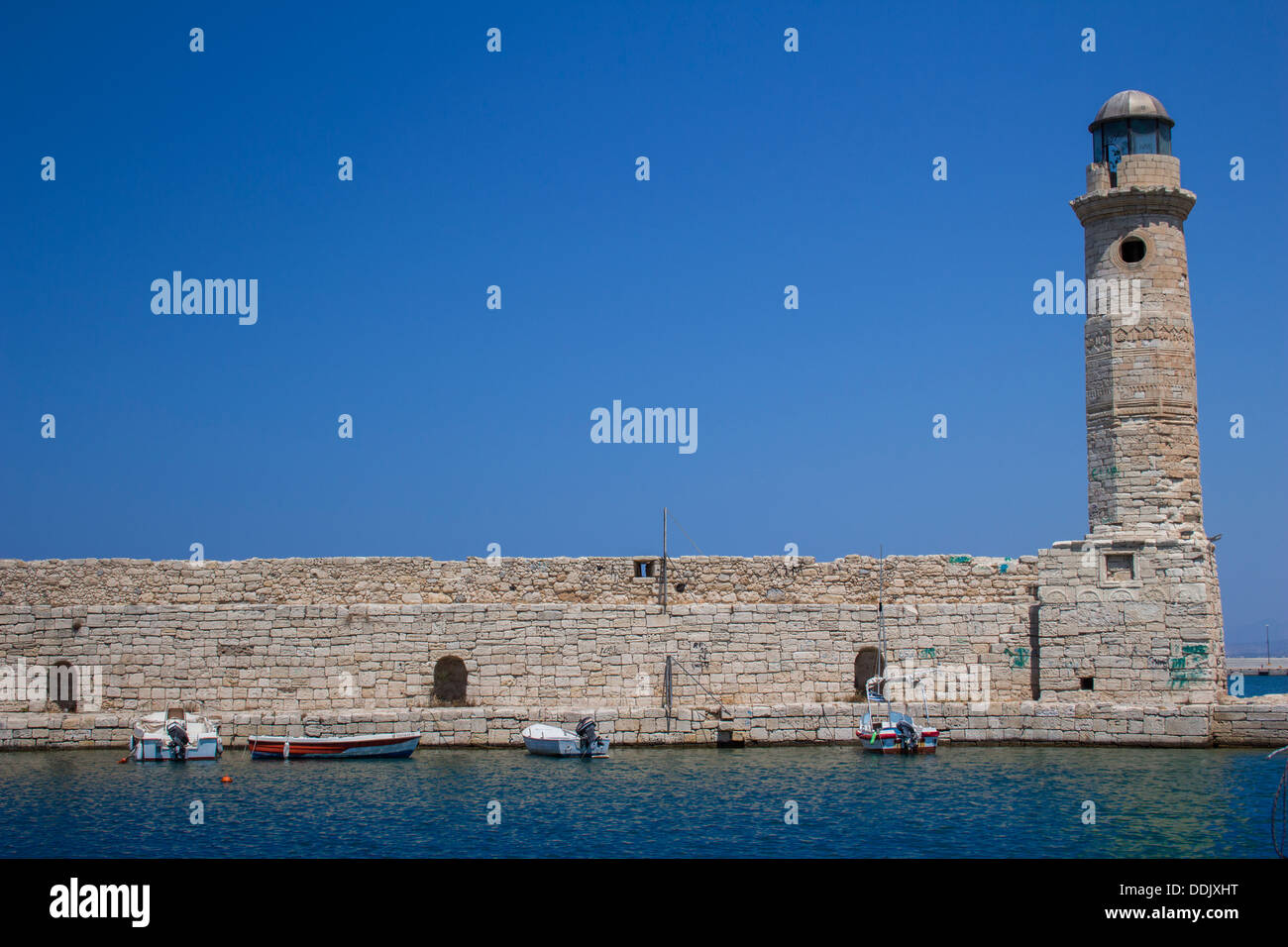 The Venetian lighthouse on the harbour wall at Rethymno in Crete Stock ...