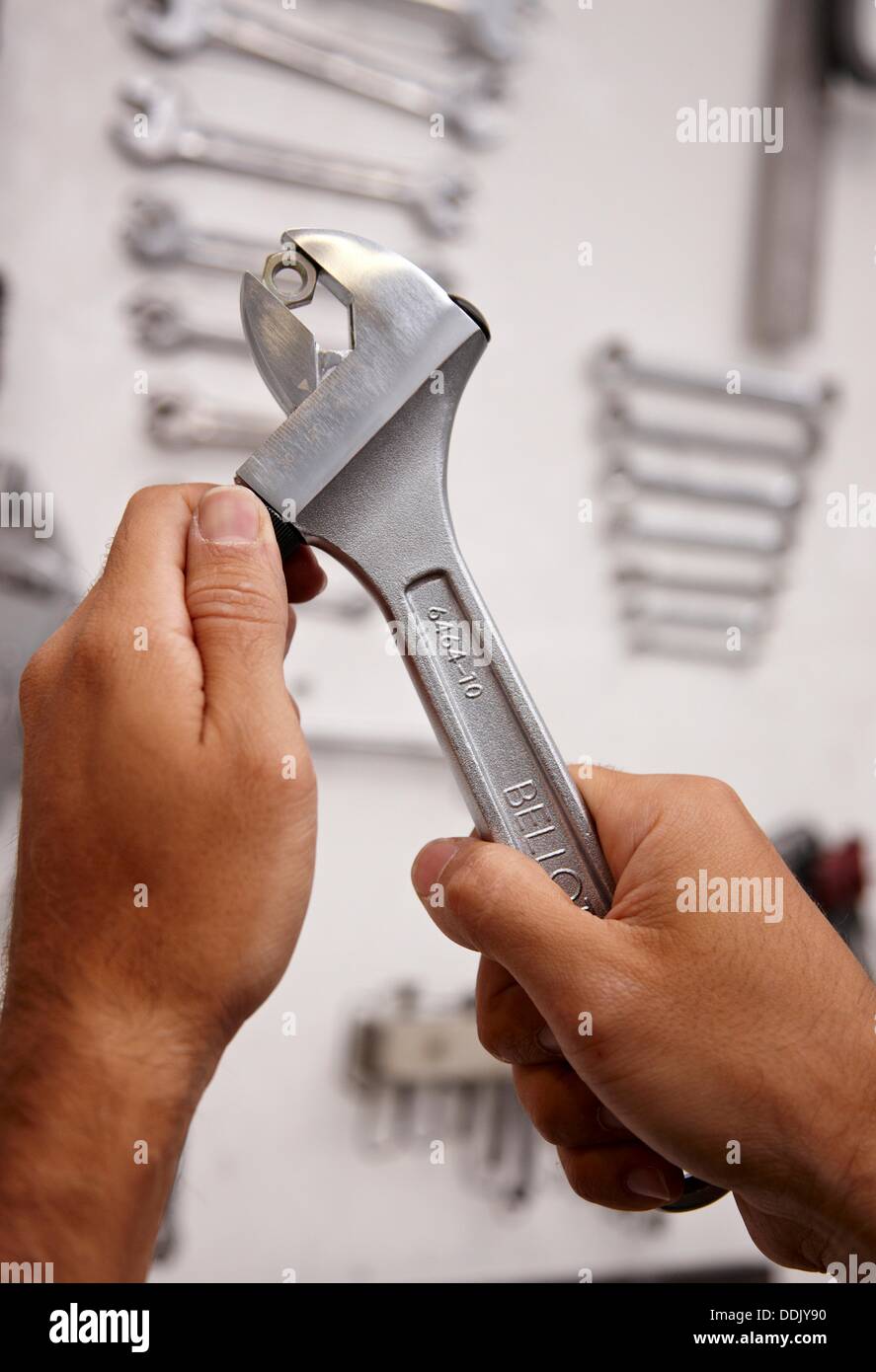 Worker holding adjustable spanner Stock Photo - Alamy