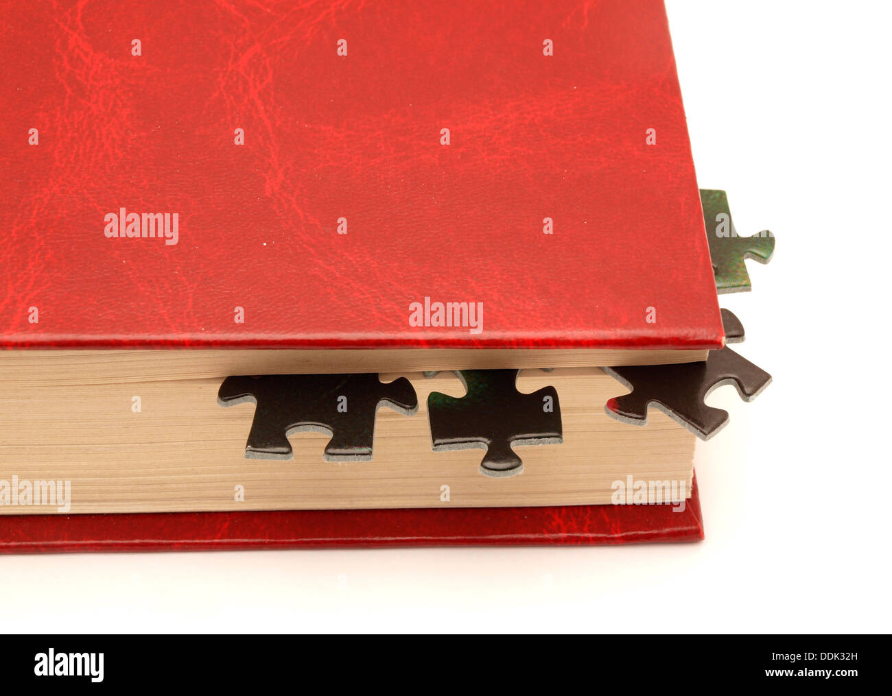 Puzzle and the book on a white background Stock Photo - Alamy