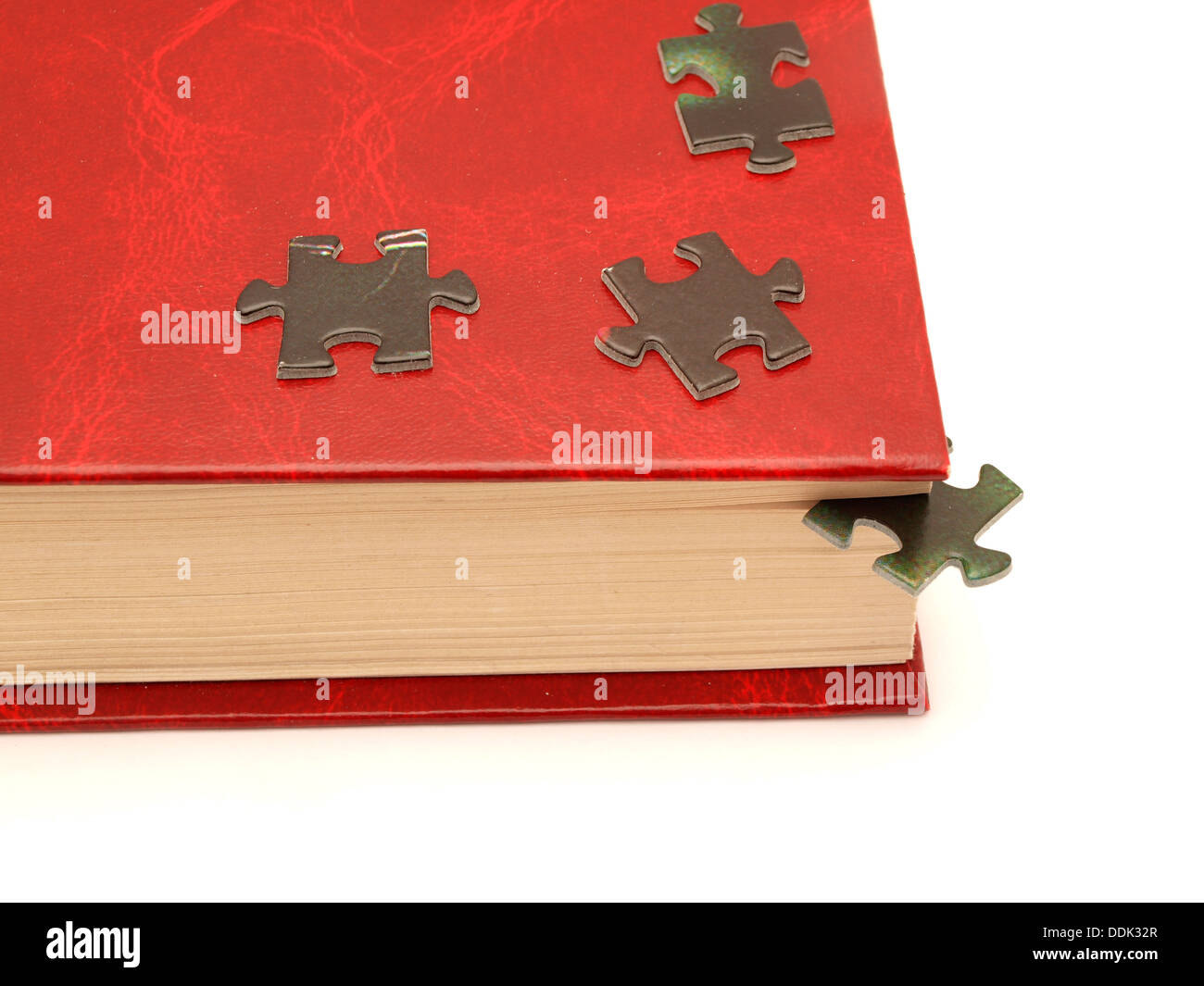 Puzzle and the book on a white background Stock Photo - Alamy