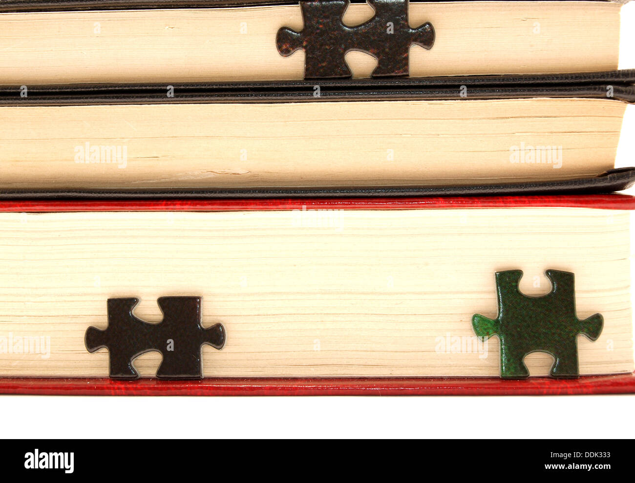Puzzle and the book on a white background Stock Photo - Alamy
