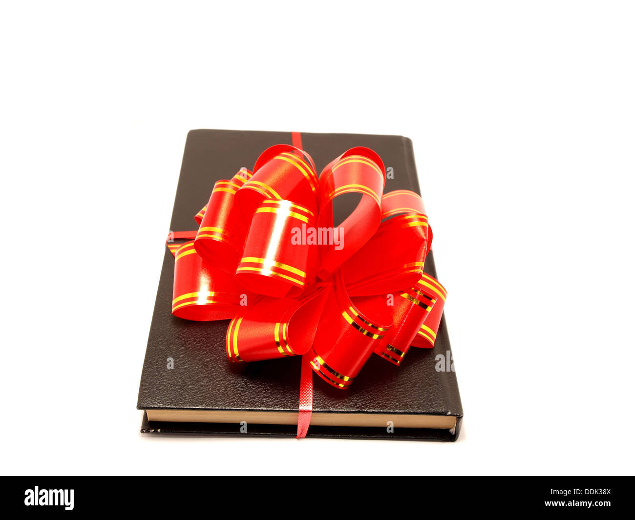The book with a bow on a white background Stock Photo - Alamy