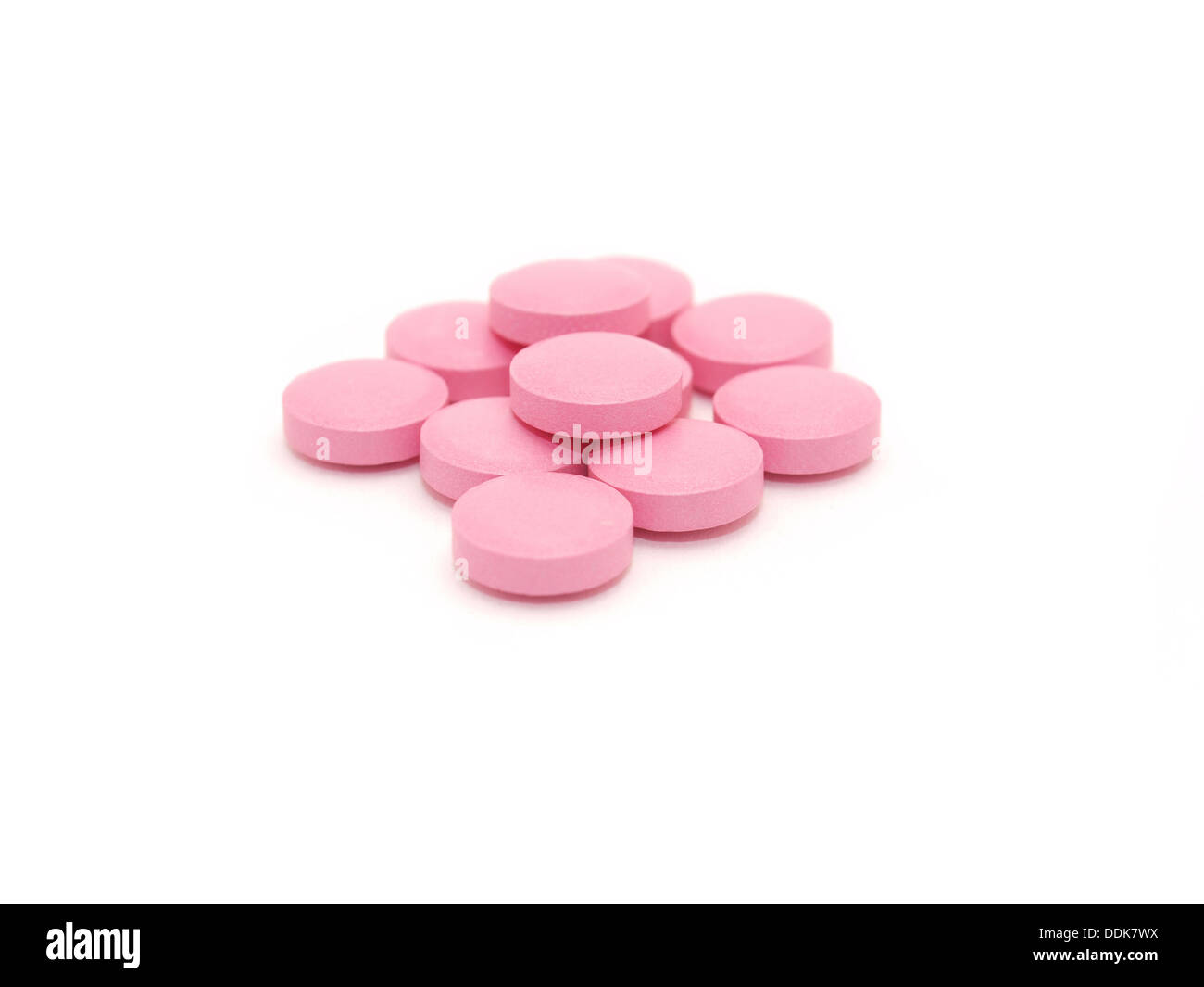 Pink tablets on a white background Stock Photo - Alamy