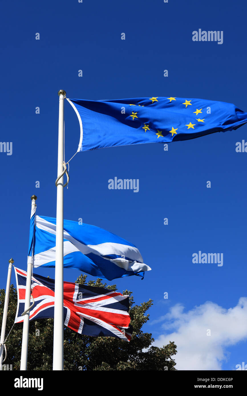 European Union, Scottish and Union Jack flags flying against a blue sky ...