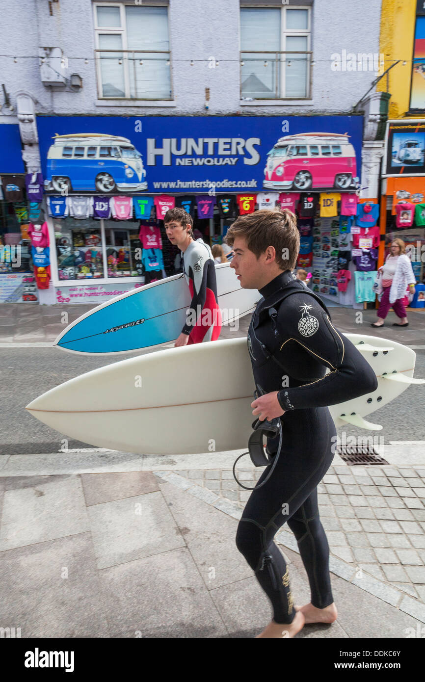England, Cornwall, Newquay, Surfers Walking Past Colourful Shops in ...