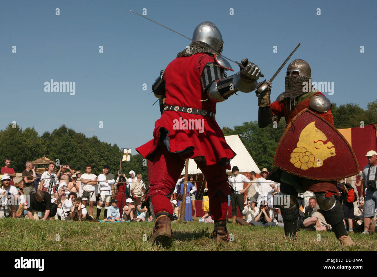Re-enactors dressed in medieval armour stage a medieval jousting ...
