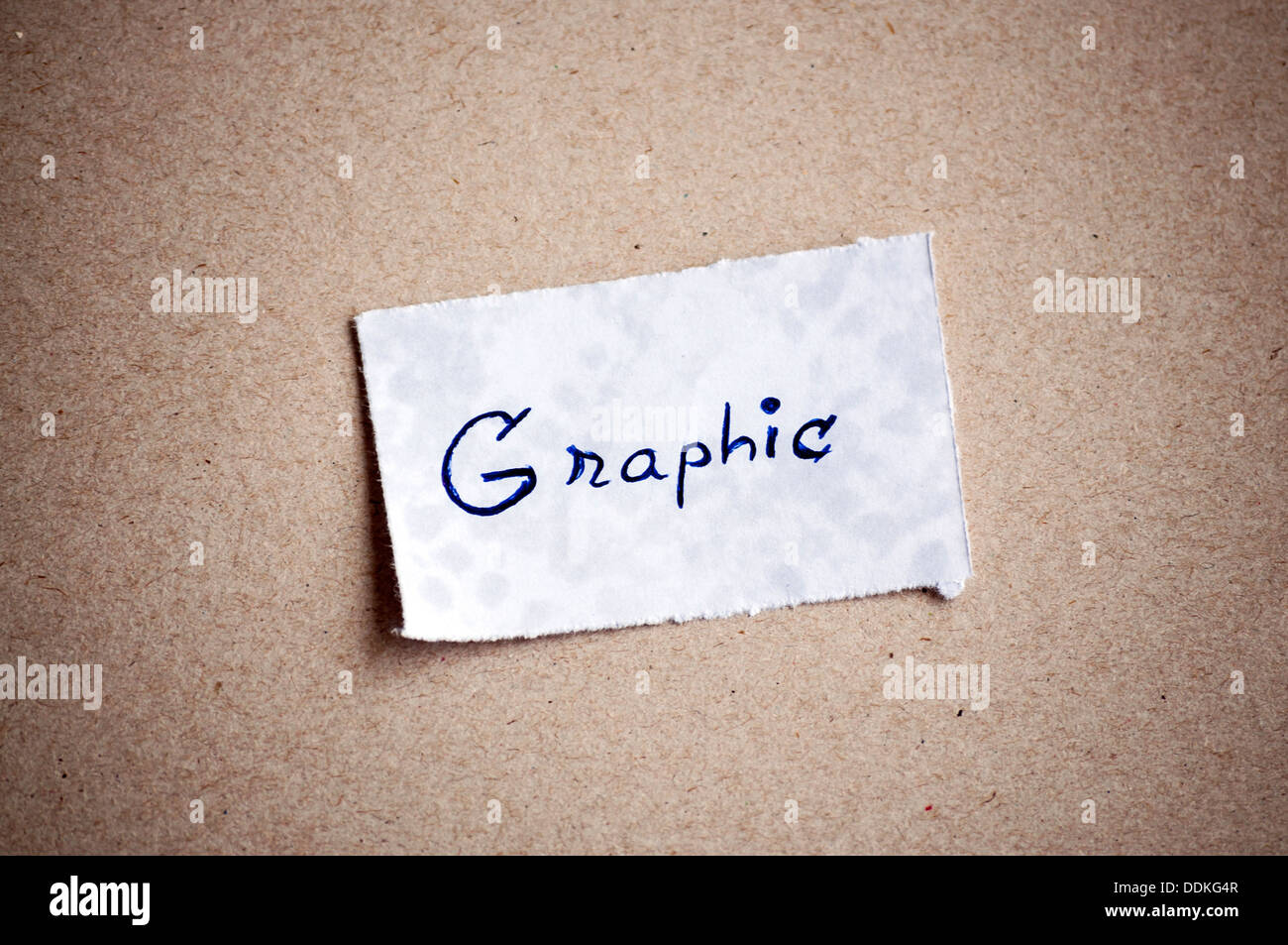 Graphic message,written on piece of paper, on cardboard background ...