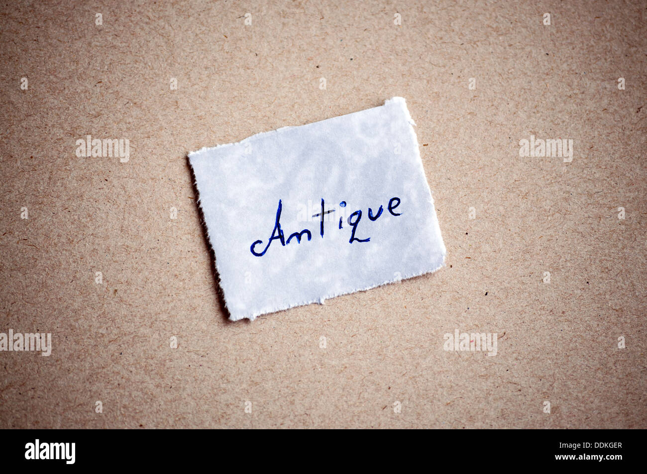 Antique message,written on piece of paper, on cardboard background ...
