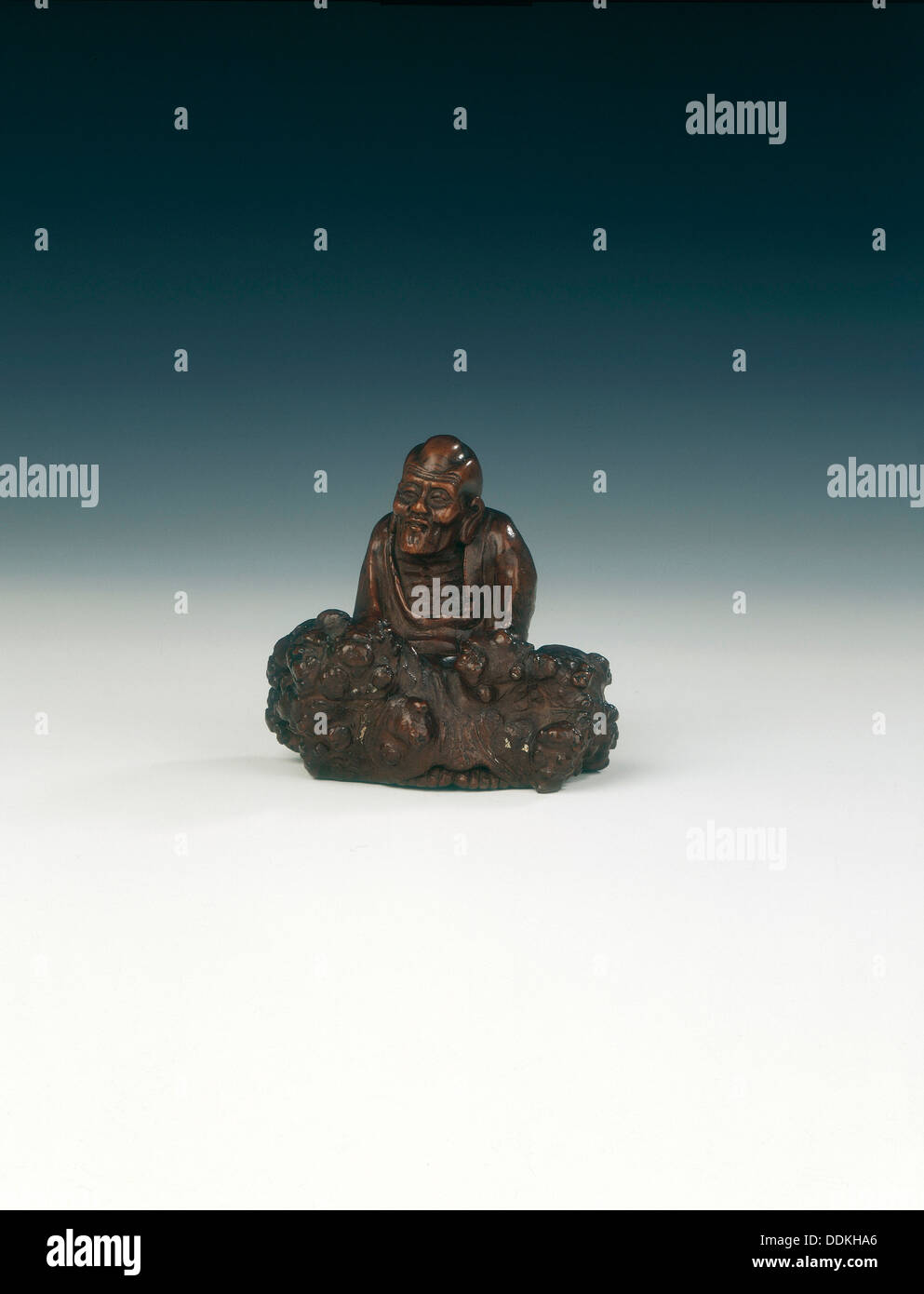 Wood carving of luohan and rock, Qing dynasty, China, 1644-1911. Artist ...