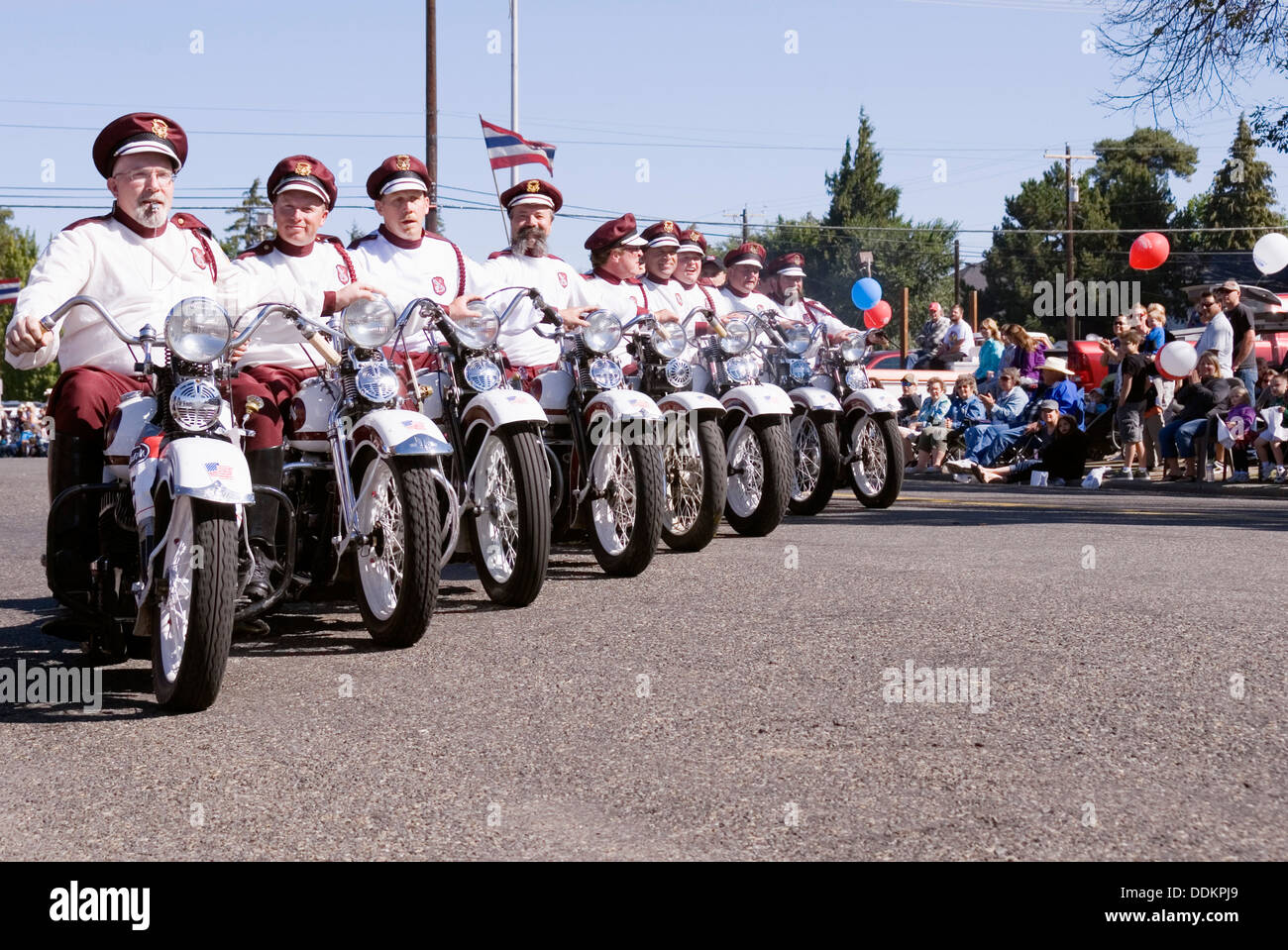 Diagonal line of motorcycles cruise Main Street, synchronized bike ...