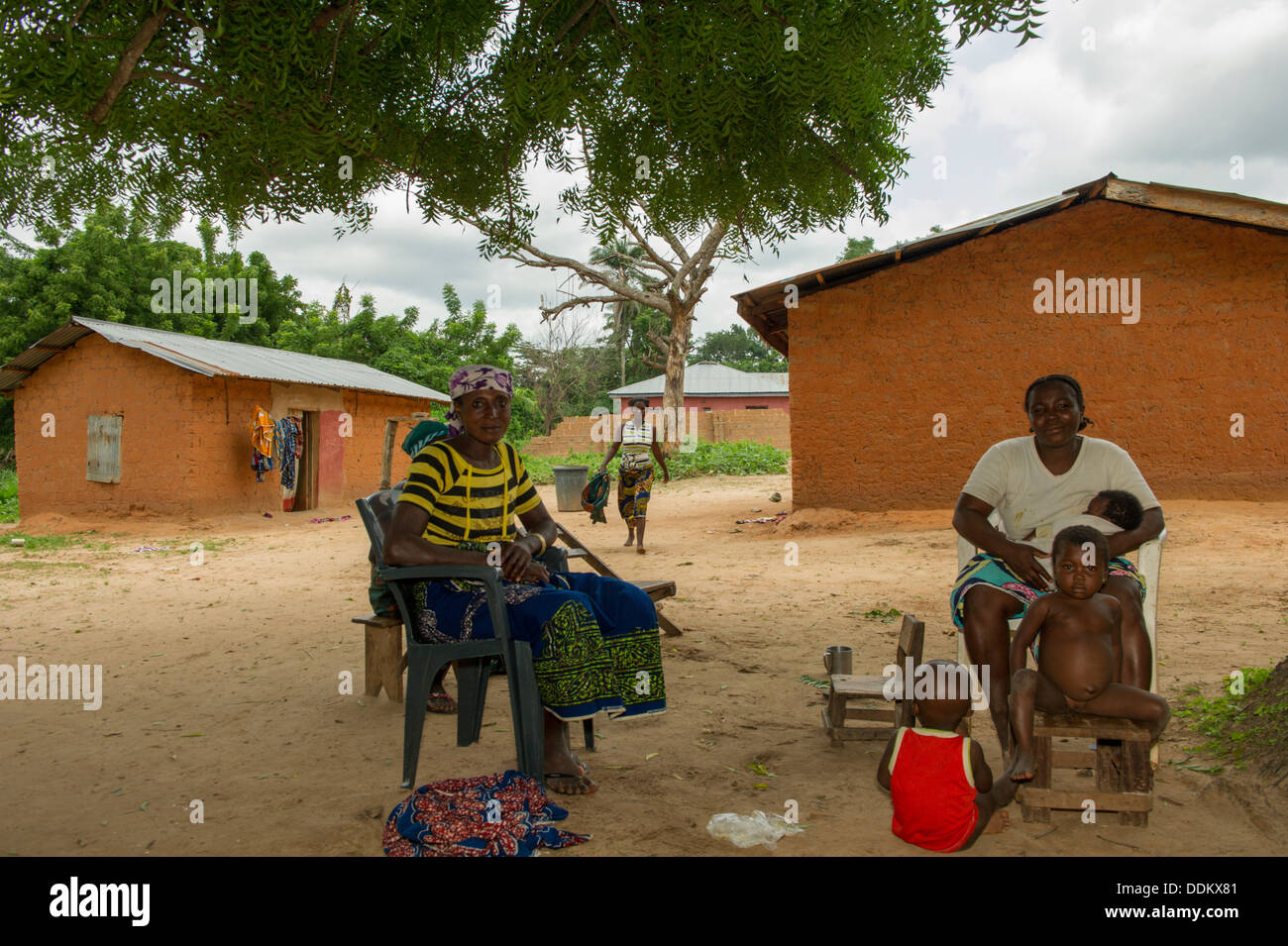 Women seating in front of their houses in the Otutulu village in ...
