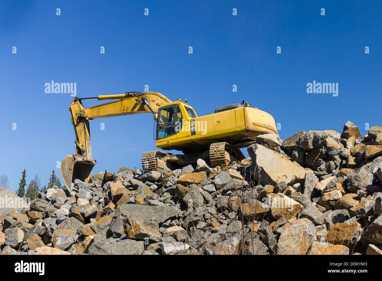 Excavator digging stone loading truck hi-res stock photography and ...