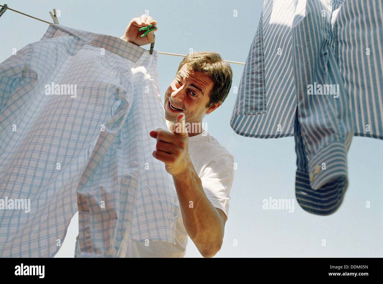 Man hanging up washing hi-res stock photography and images - Alamy