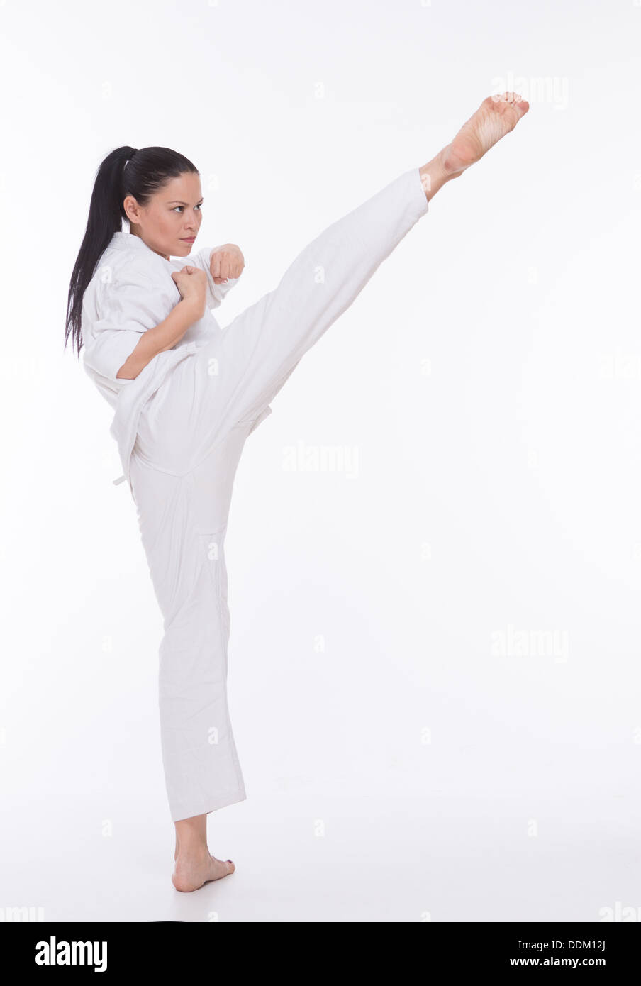 Beautiful asian woman makes kick in kimono on white Stock Photo - Alamy