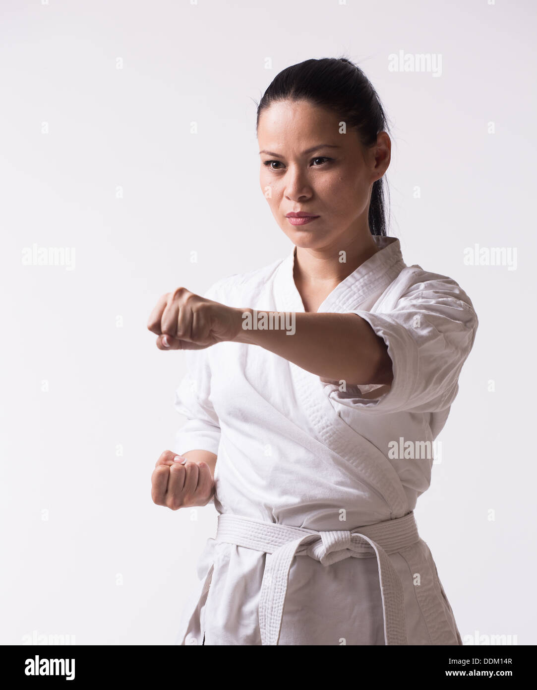 Woman show punch in martial art exercise Stock Photo - Alamy