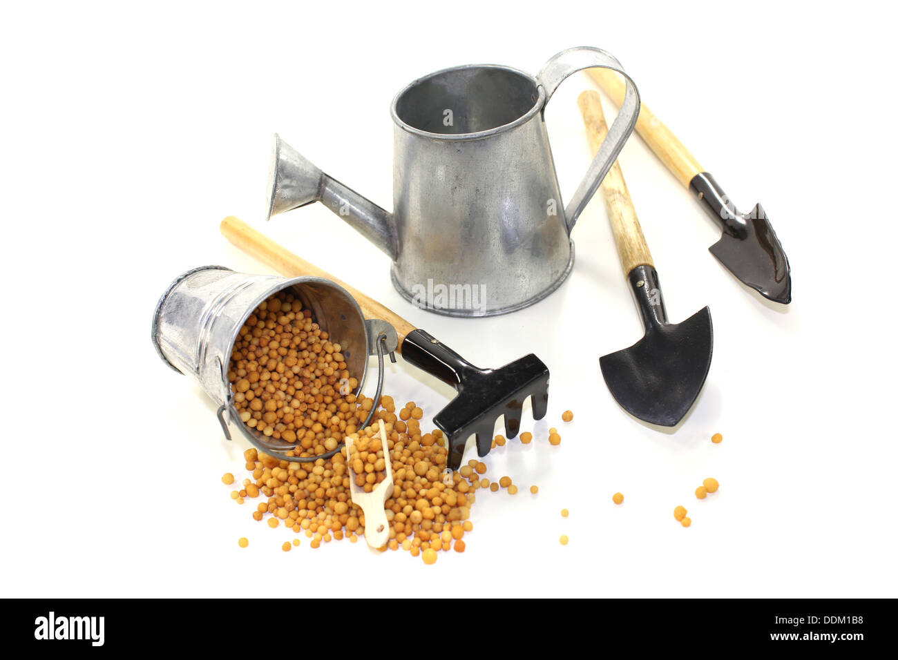 Fertilizer with watering can on a bright background Stock Photo - Alamy