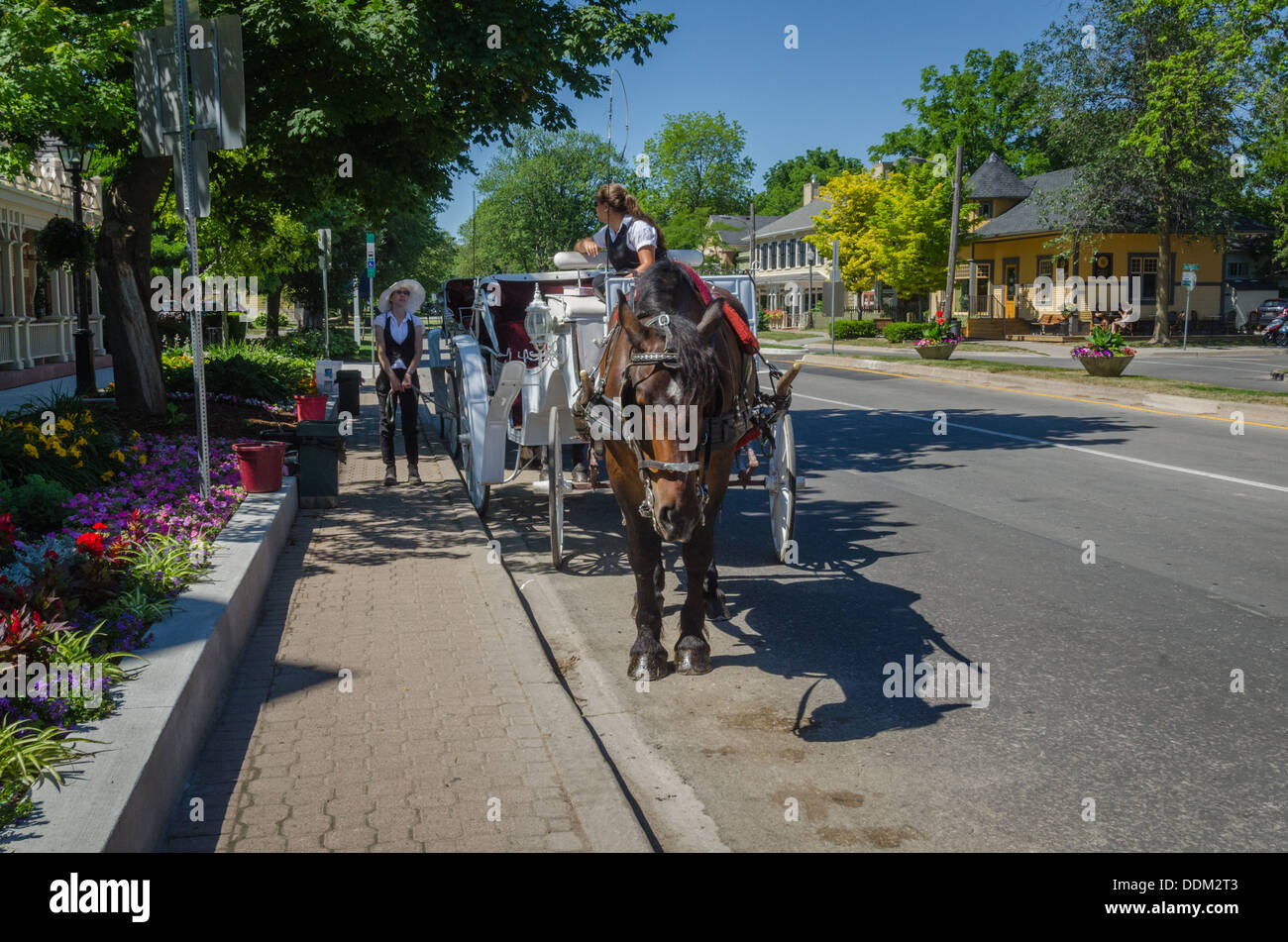 A horse and buggy tour operator waits for tourists in historic Niagara ...