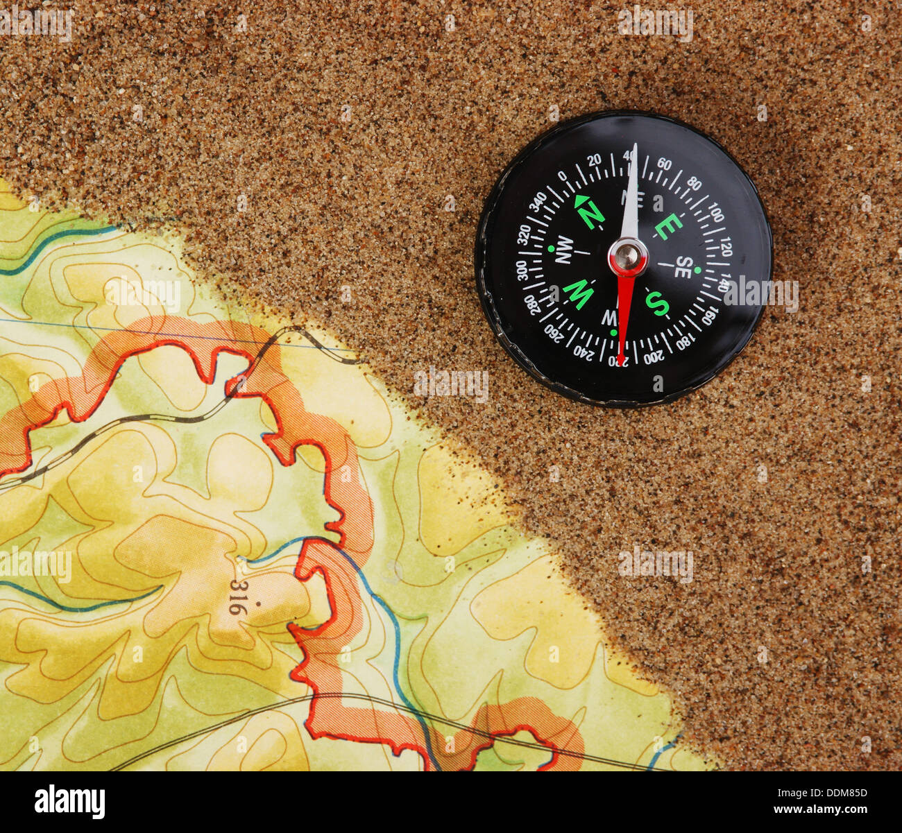 compass on the map with sand Stock Photo - Alamy