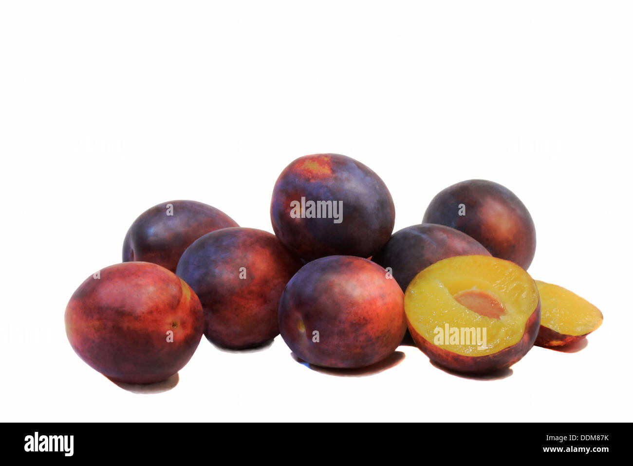 Large ripe plum and one exploded drain on white background Stock Photo ...