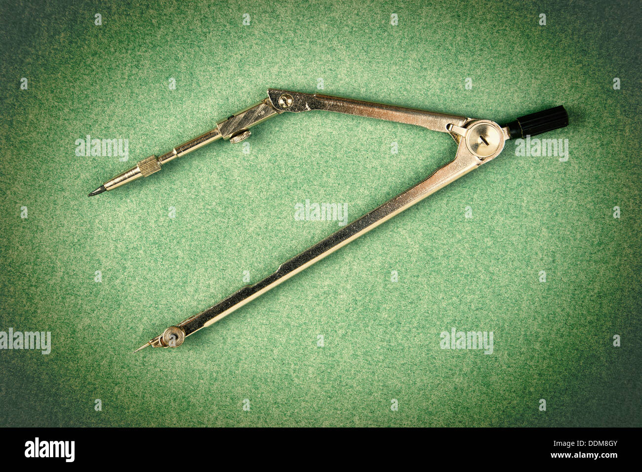 Old drawing tools on a green background Stock Photo - Alamy