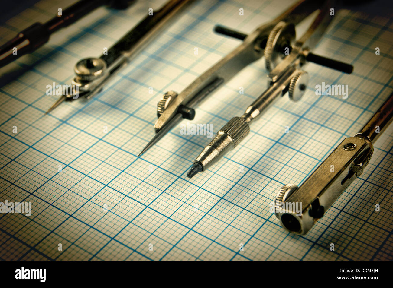 Old drawing tools on graph paper Stock Photo - Alamy