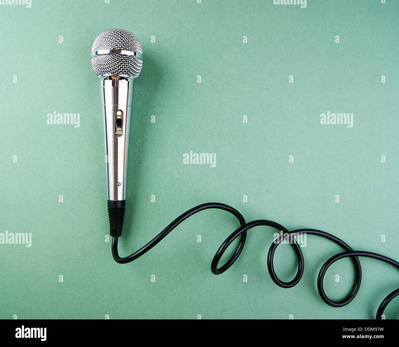 Classic dynamic microphone on a green background Stock Photo - Alamy
