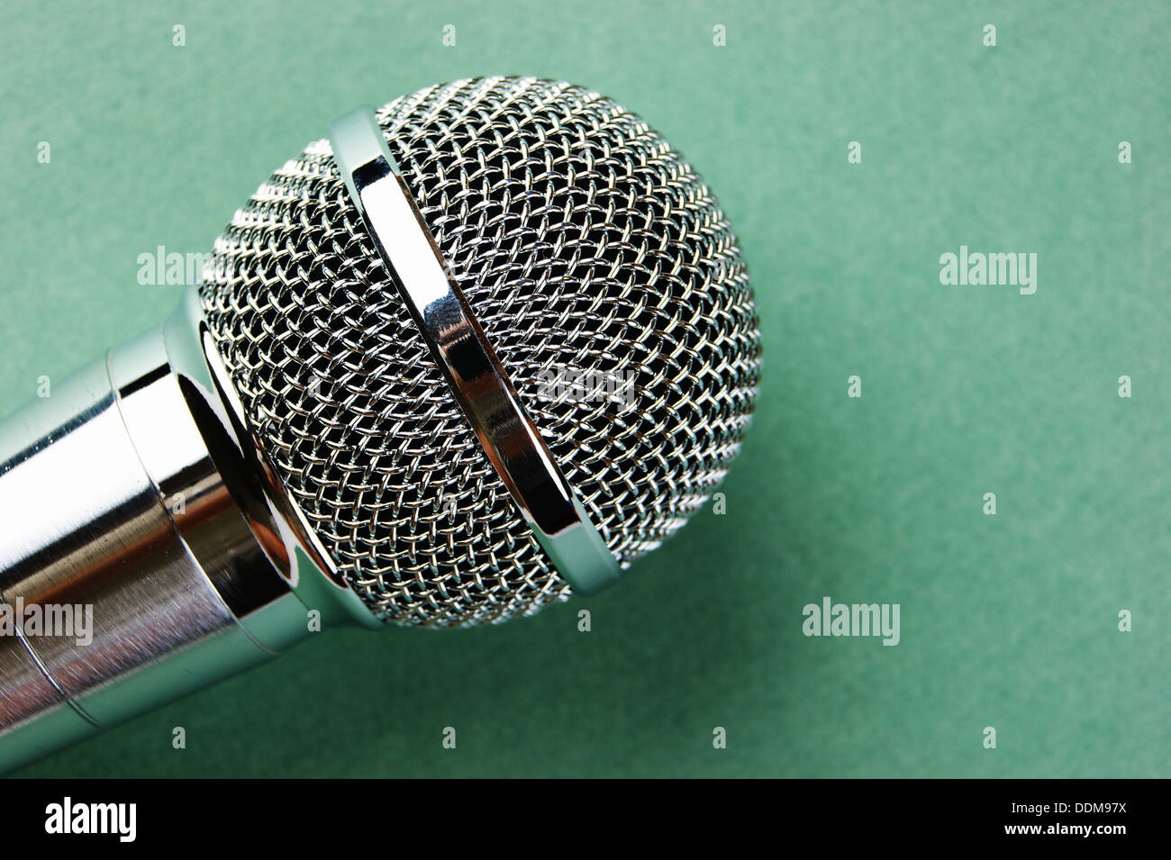 Classic dynamic microphone on a green background Stock Photo - Alamy