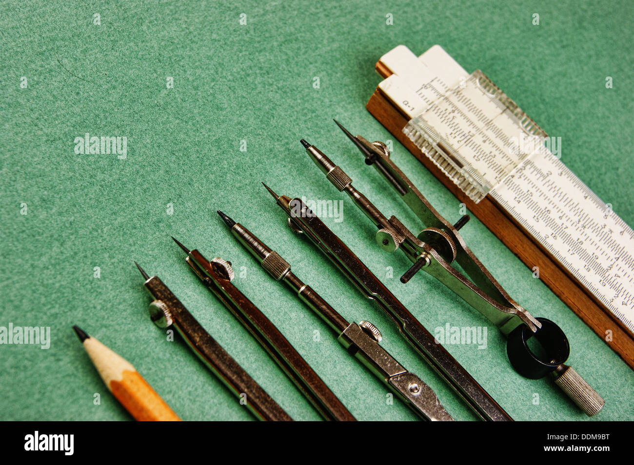 Old drawing tools on a green background Stock Photo - Alamy