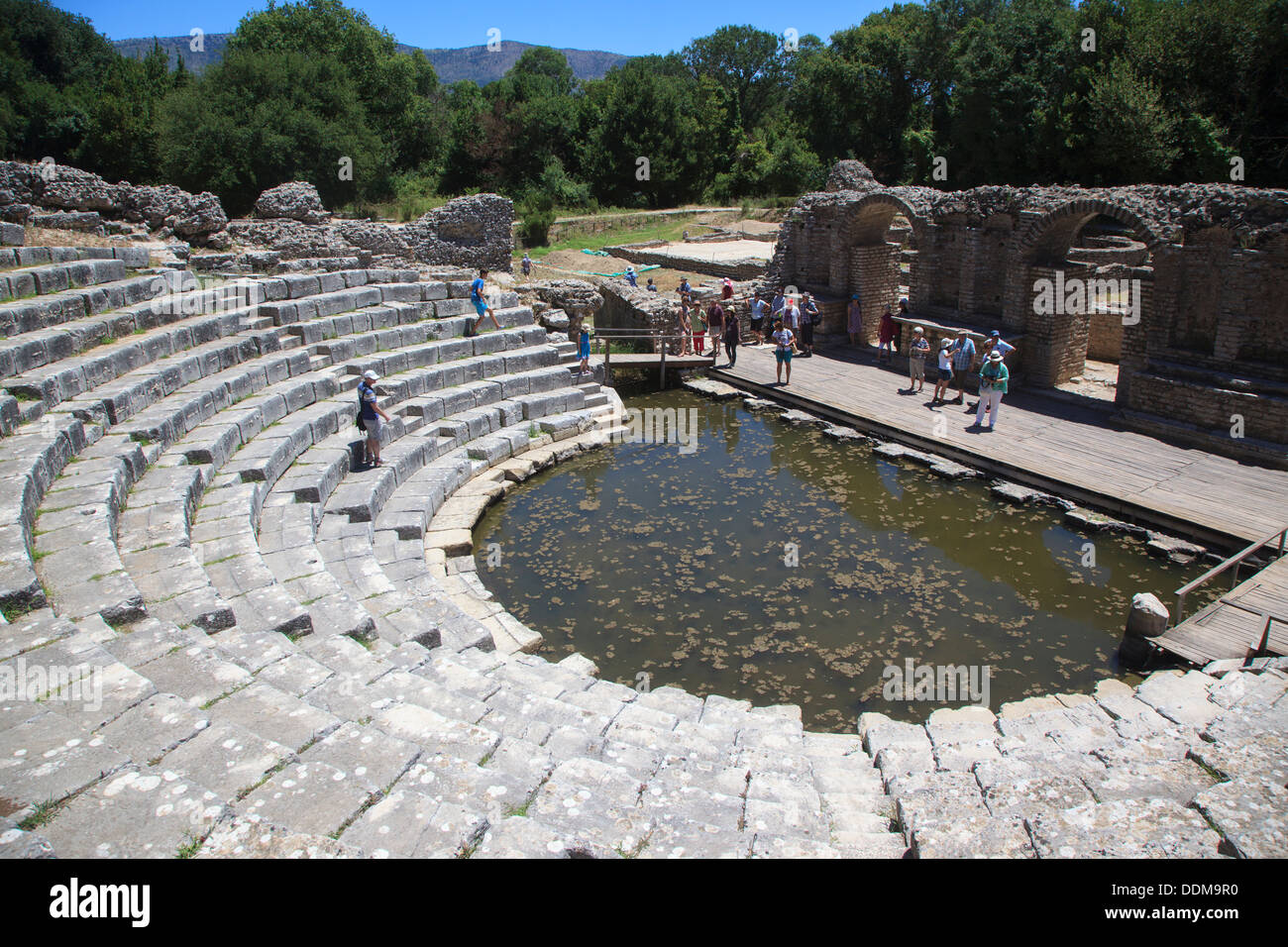 Tourists viewing the remains of the amphitheatre at Butrint Albania ...