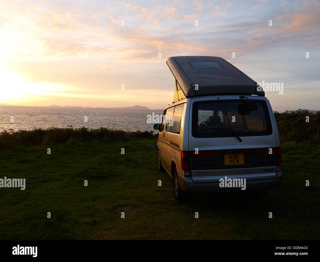 Sunset and Mazda Bongo with elevated roof in Shell Island Gwynedd North ...