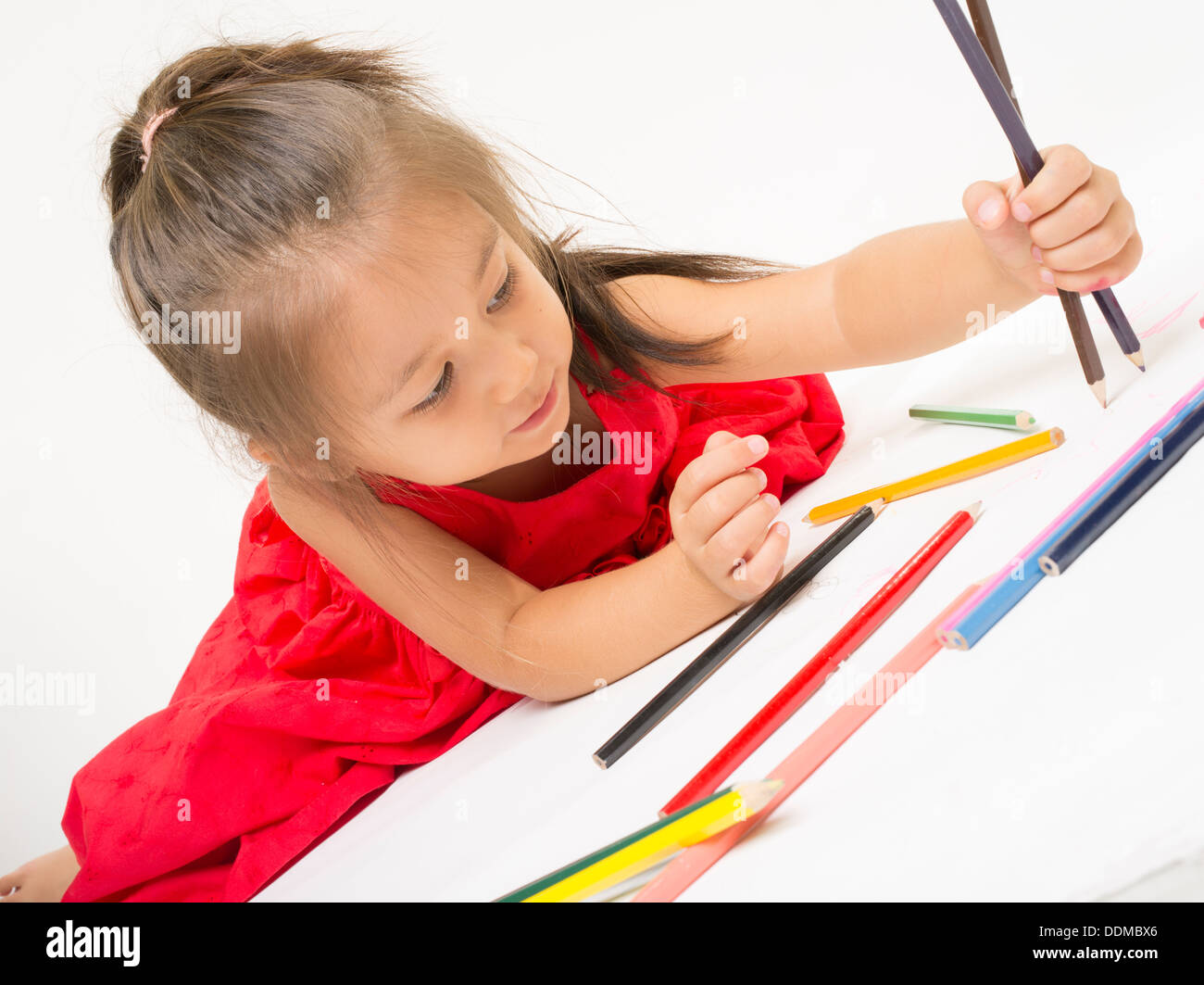 Young girl coloring with colored pencils Stock Photo - Alamy