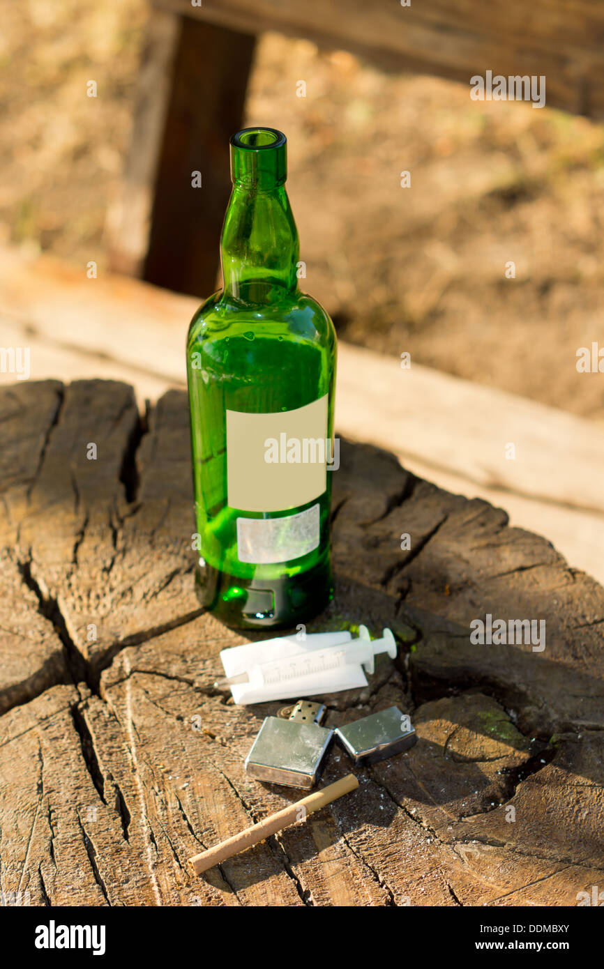 Close-up of objects - symbols of addictive habits: a bottle of ...
