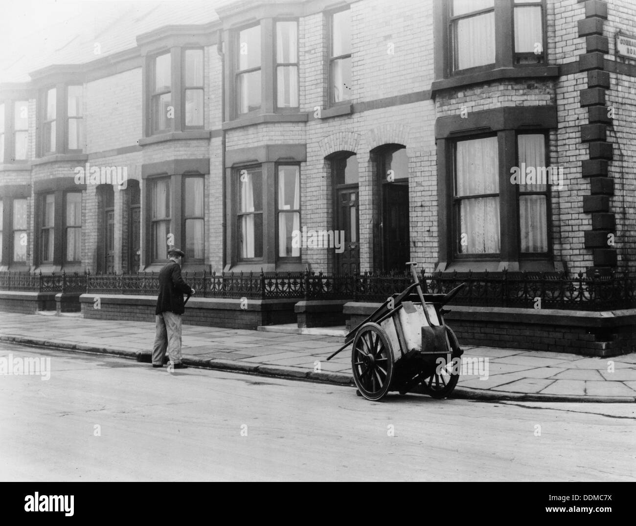 An 'Orderly Boy' and his cart sweeping a street, Liverpool, 1935 ...