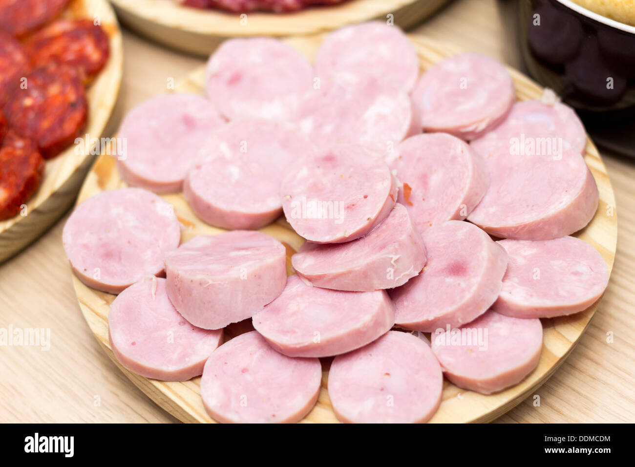 White botifarra sliced on top of a wooden board Stock Photo - Alamy